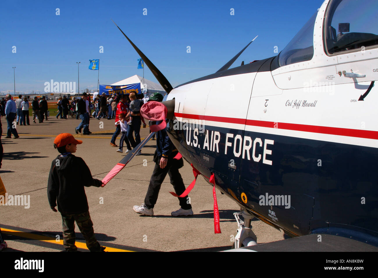 Boy investigating US Air Force prop plane Stock Photo - Alamy