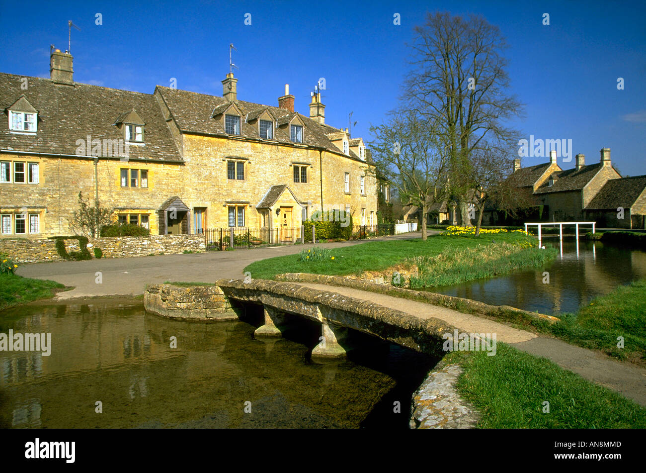 In Lower Slaughter a small stone foot bridge crosses the River Eye ...