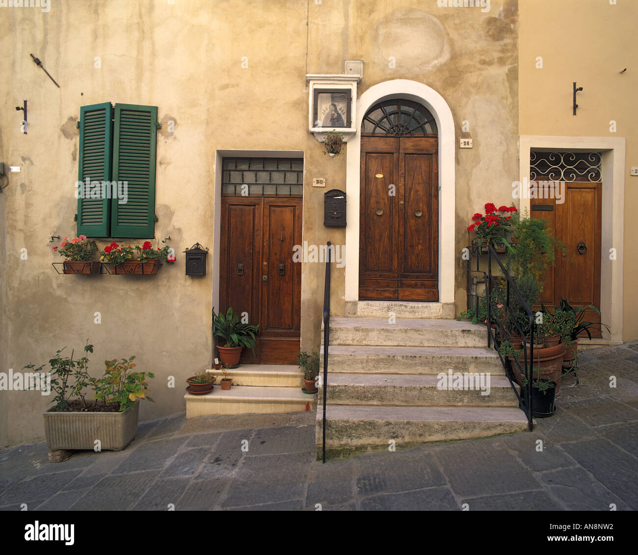 Tuscany Italy Three doors and steps on a slanted street in the ancient ...