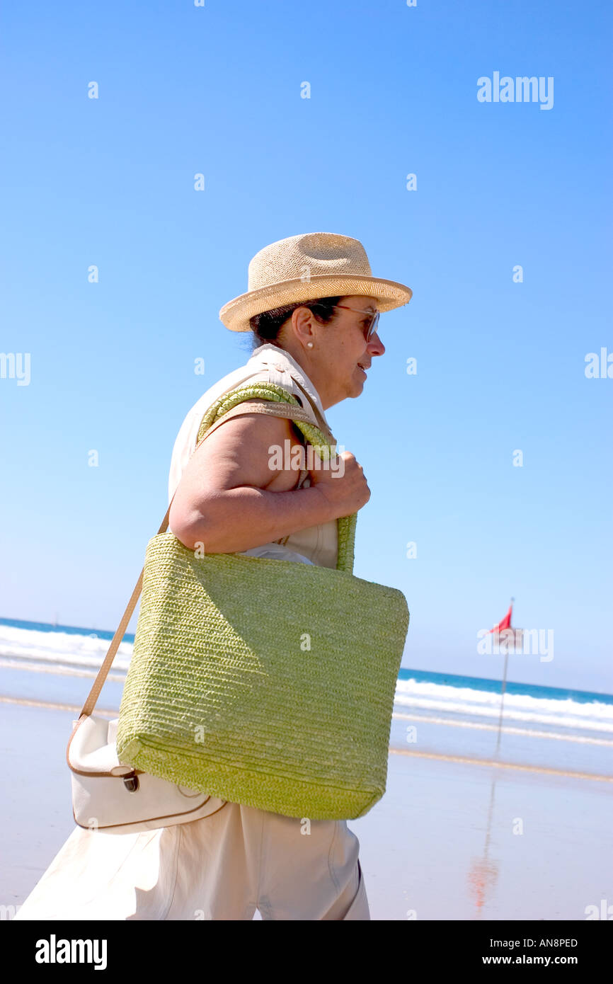 woman walking alone on beach with sunny day in summer Stock Photo - Alamy