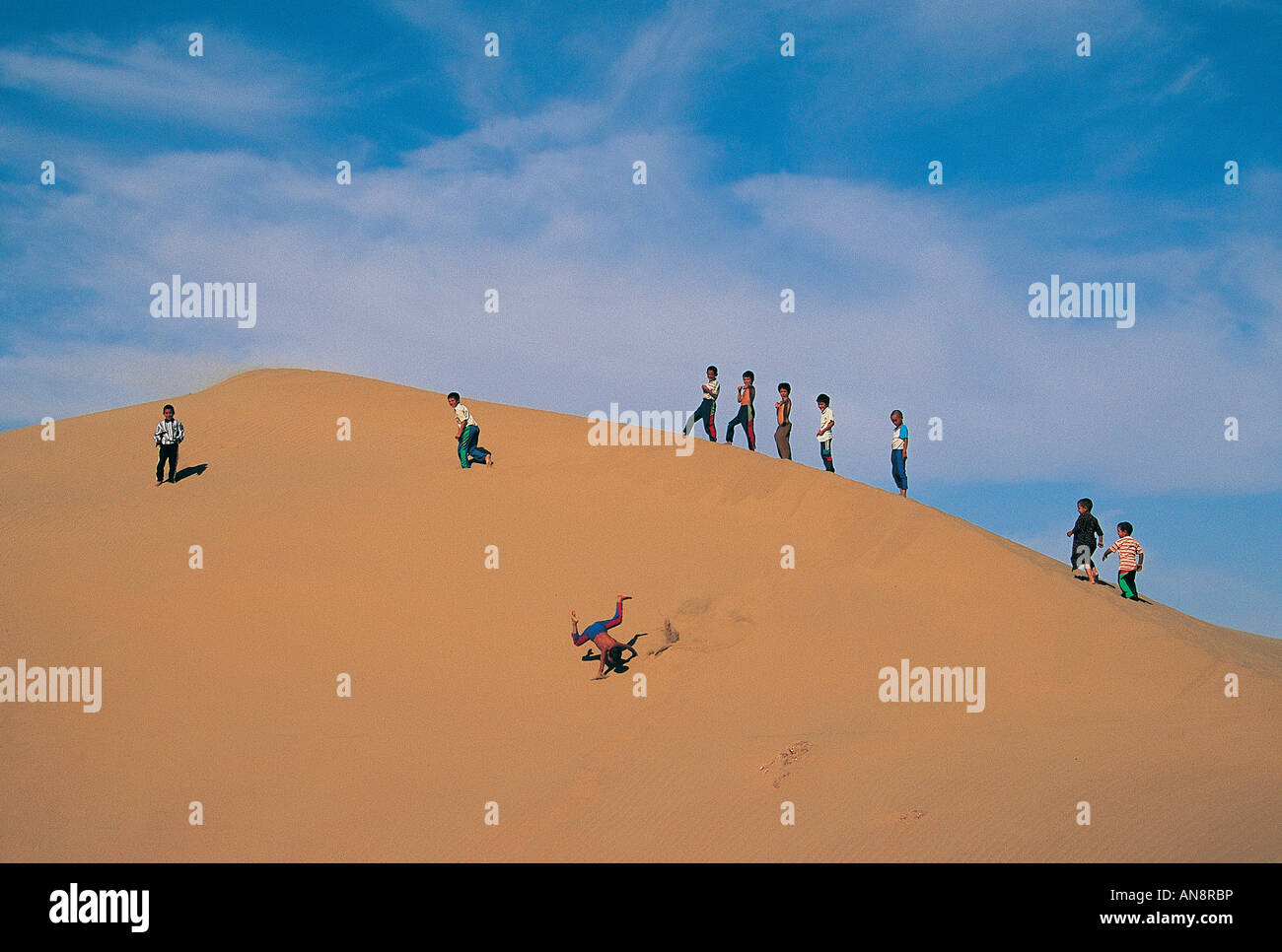 Children playing on dunes of Karakoram Desert , Turkmenistan Stock ...