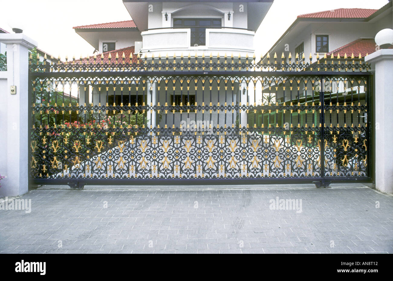 Wide roller track cast alloy gate in front of a house in Bangkok ...