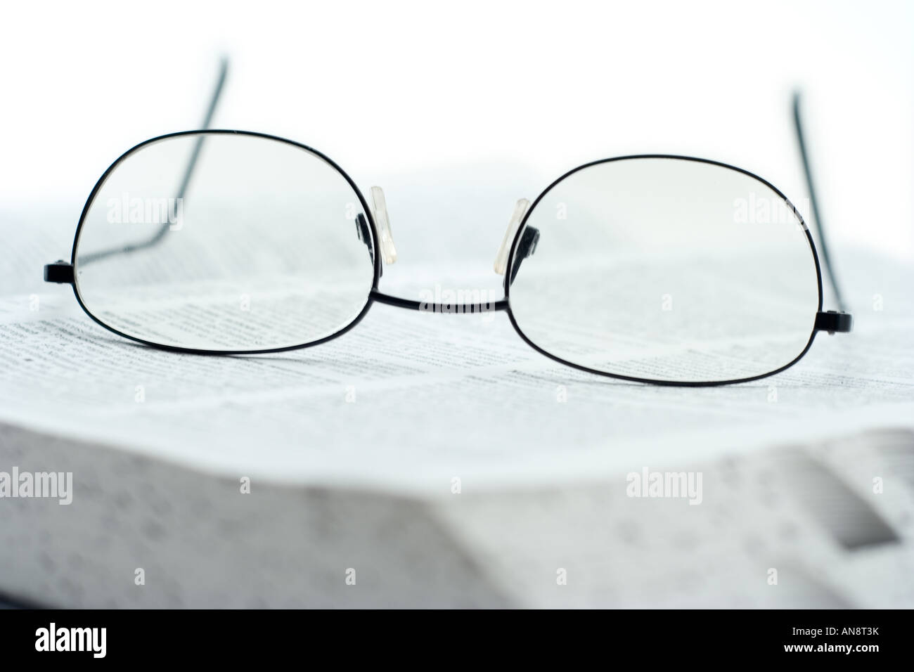 Glasses on a book Stock Photo - Alamy