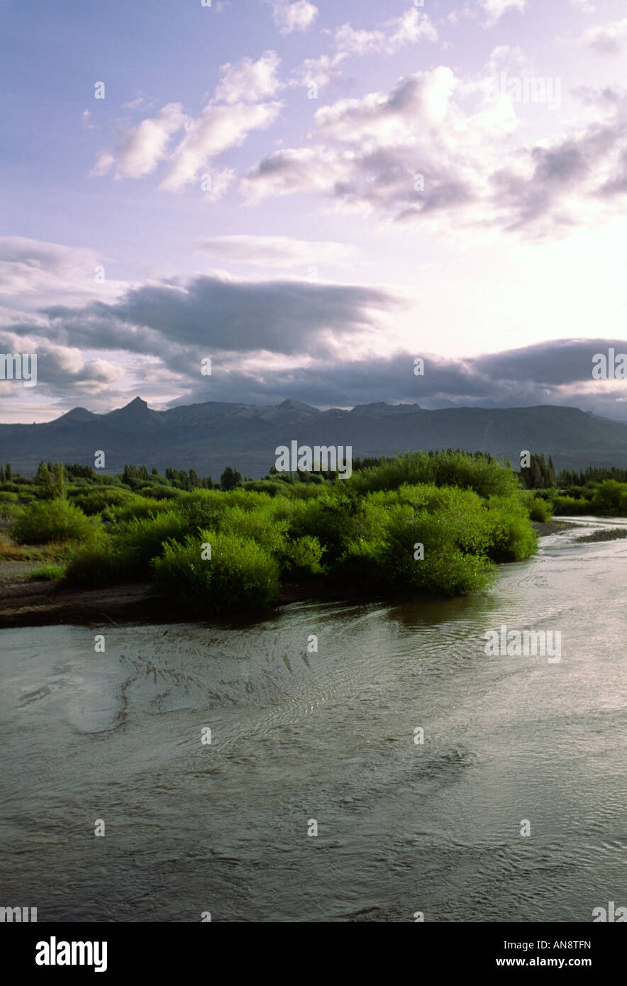 A river runs from the foothills of the Andes mountains through a broad ...