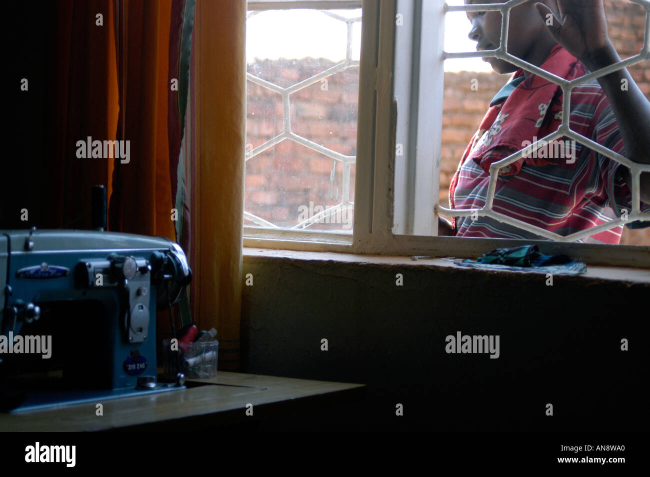 woman in window in kigali rwanda Stock Photo - Alamy