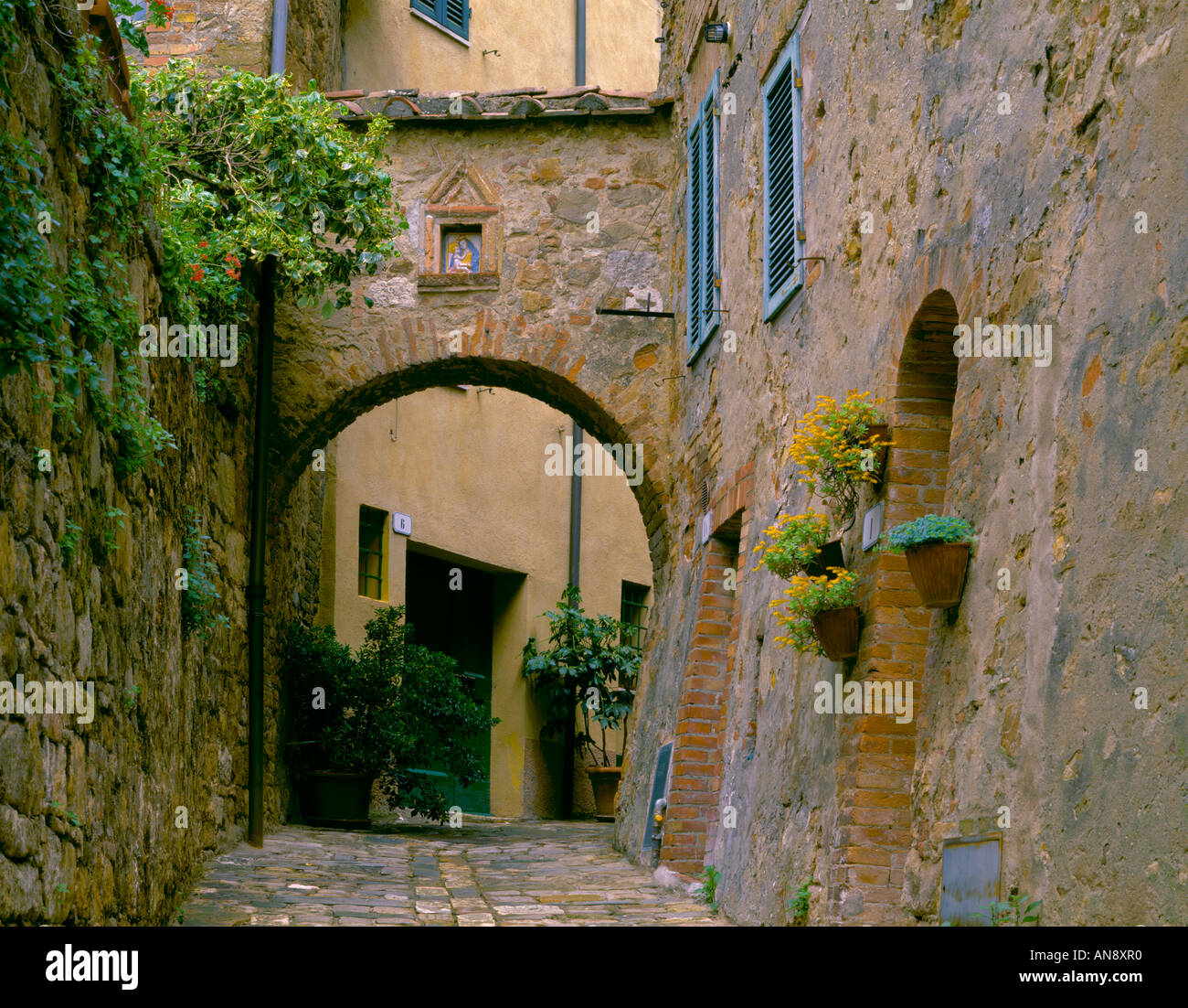 Tuscany Italy Street Scene with stone walls walkway and arched passage ...