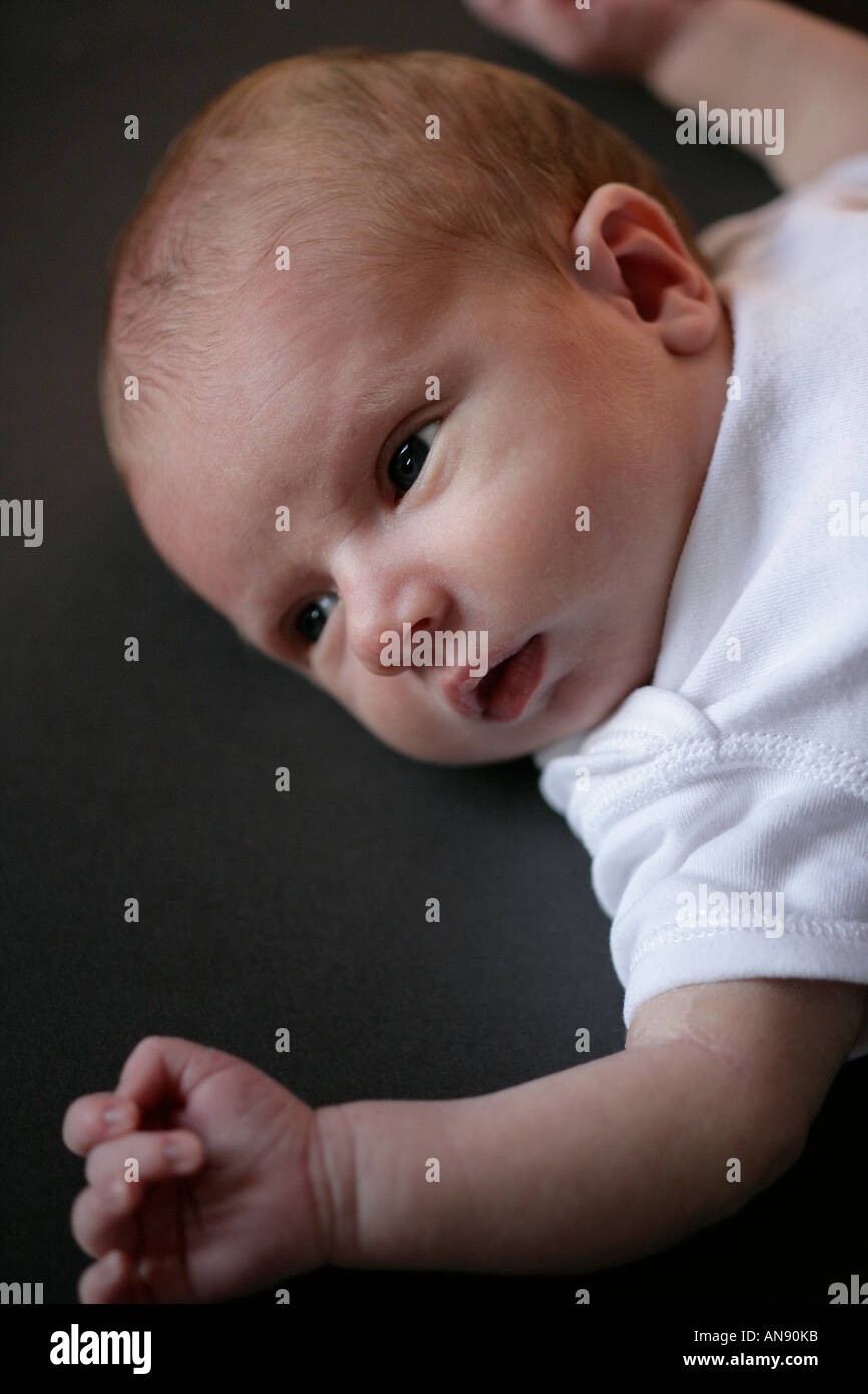 Baby lying down Stock Photo - Alamy
