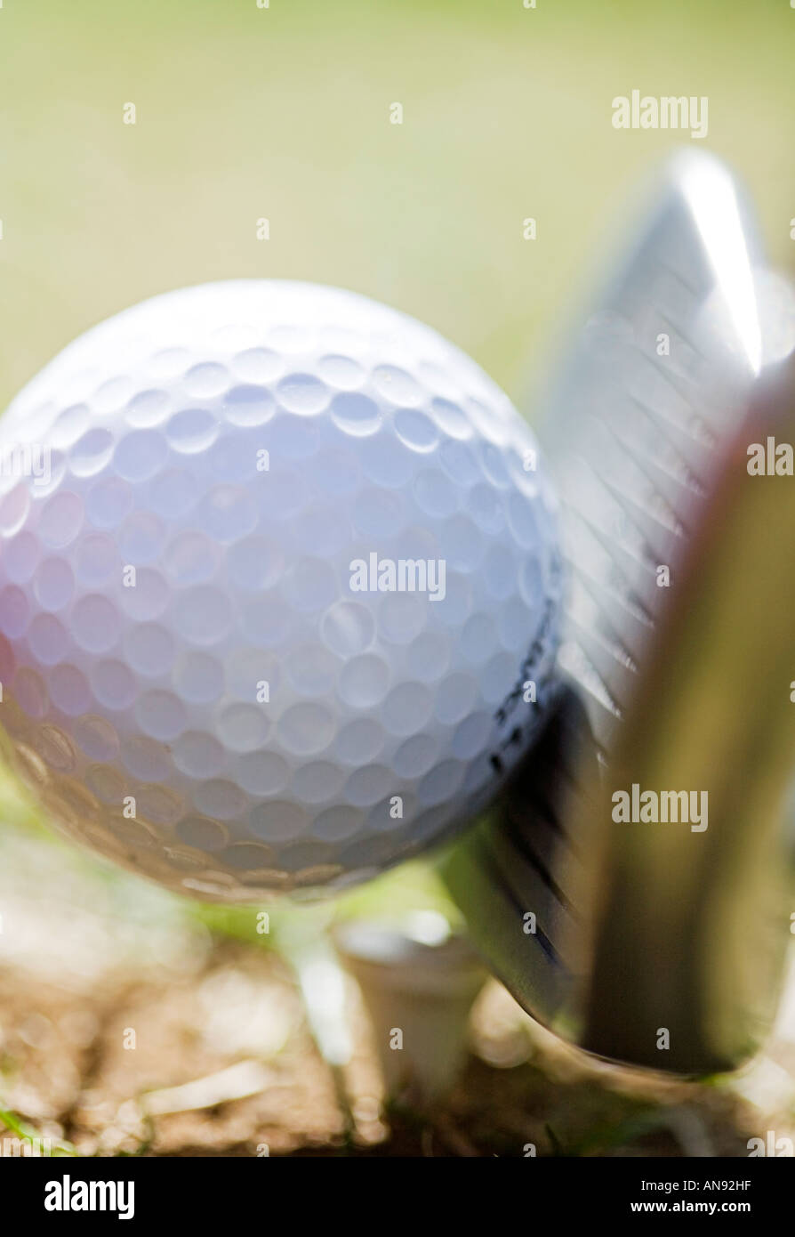 Teeing off 3 iron golf club hitting white ball on wooden tee Stock ...