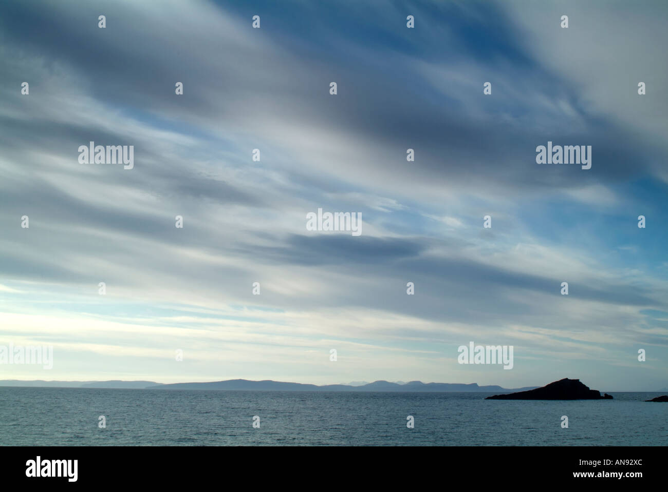 Silhouetted outline of the Isle of Skye on the crossing from North Uist ...