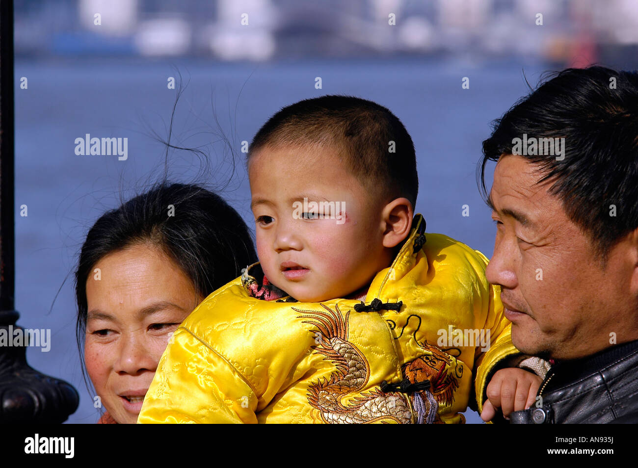 Portrait of a Chinese child dressed in a yellow little emperor coat ...