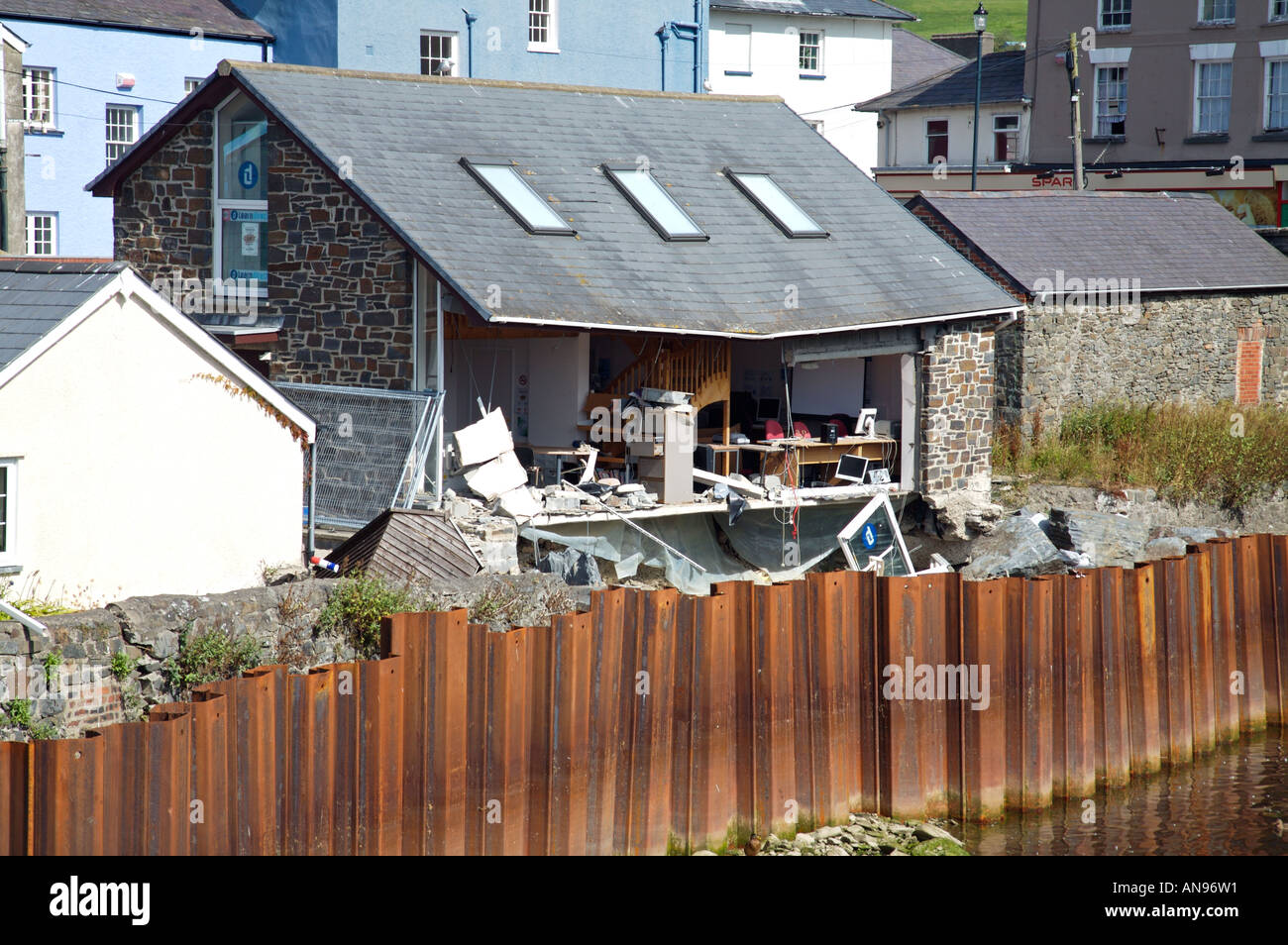 View of an office with one wall collapsed leaving the inside open to ...