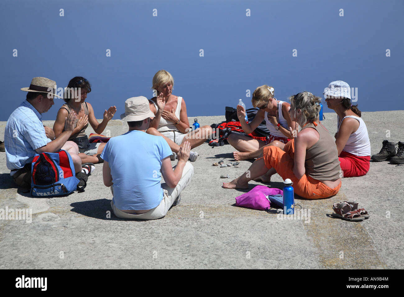 Group meditation at the top of Mount Maolo, Elba, Tuscany, Italy Stock ...