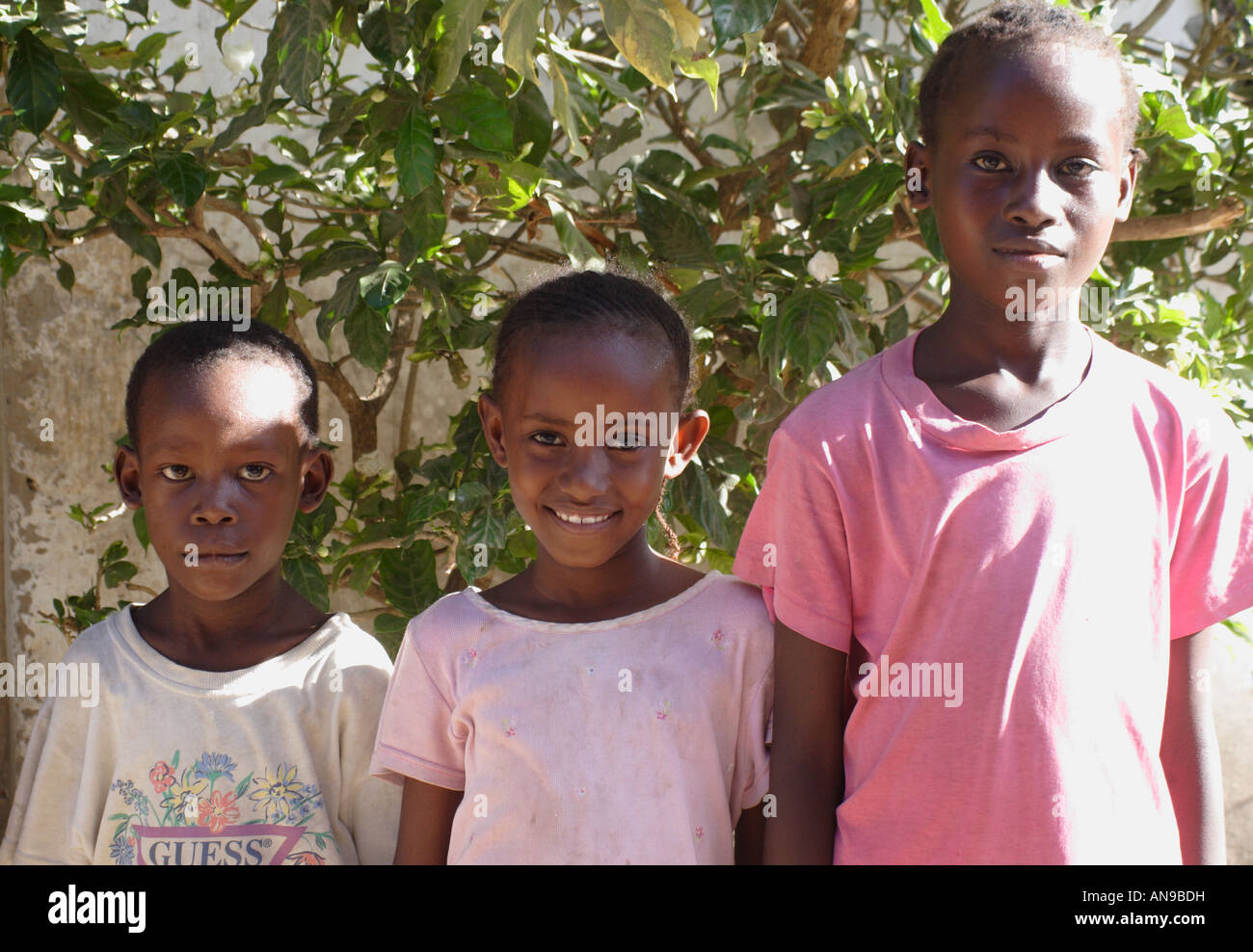 Three friendly children happy to pose for pictures in the Kenyan ...