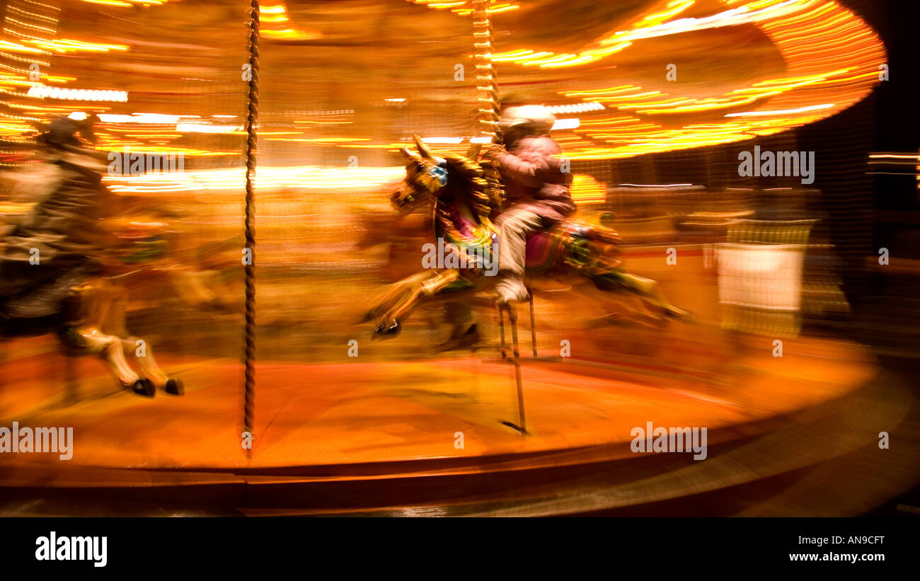 Child on a roundabout fun fair ride Stock Photo - Alamy