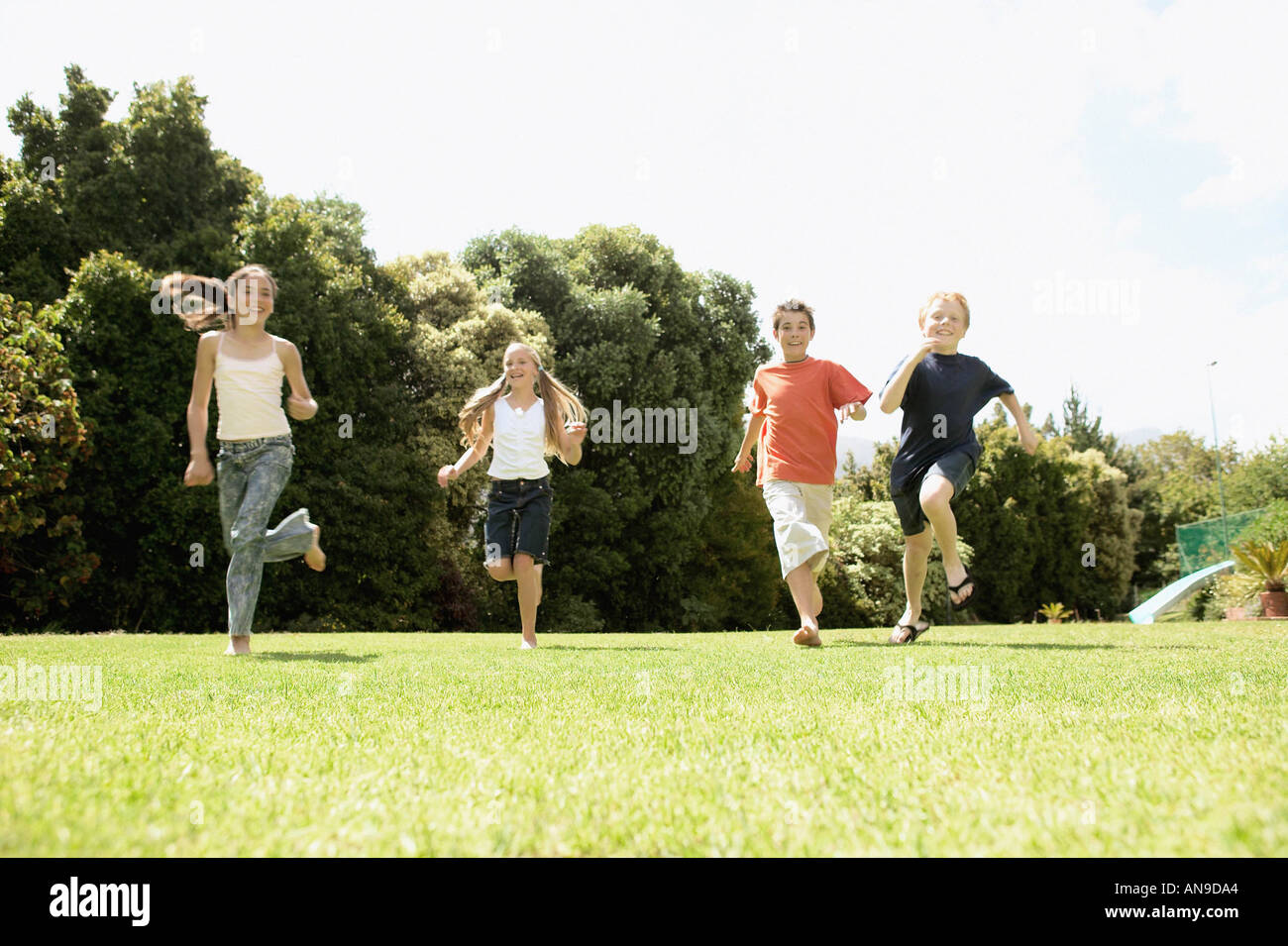 Children running on grass hi-res stock photography and images - Alamy