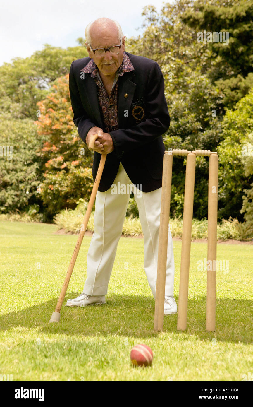Umpire leaning on a walking stick Stock Photo - Alamy