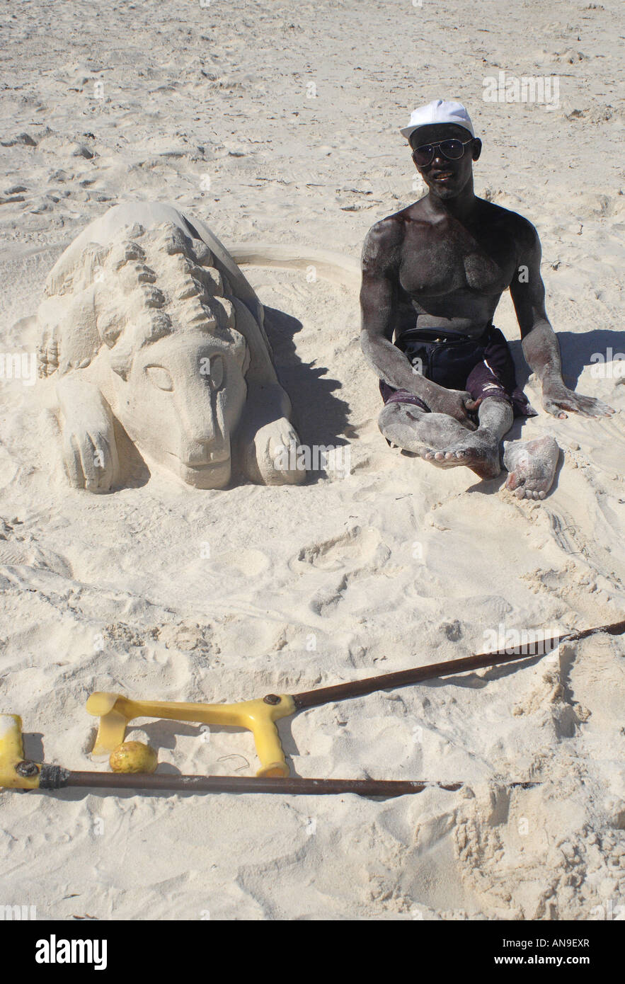 Crippled sand sculptor by his daily masterpiece on the beach at Shanzu ...