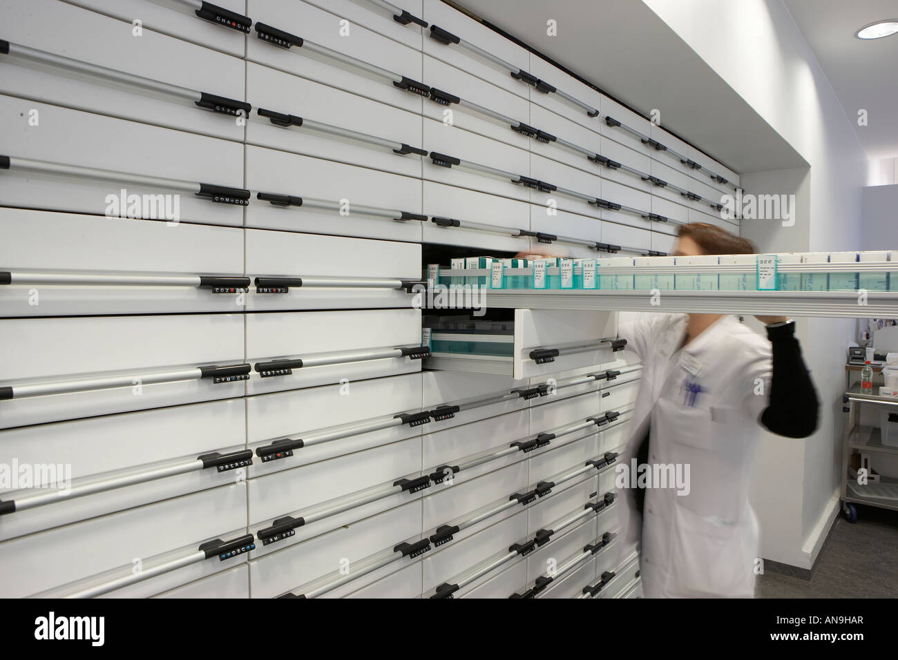 Pharmacist searching for medications Stock Photo - Alamy