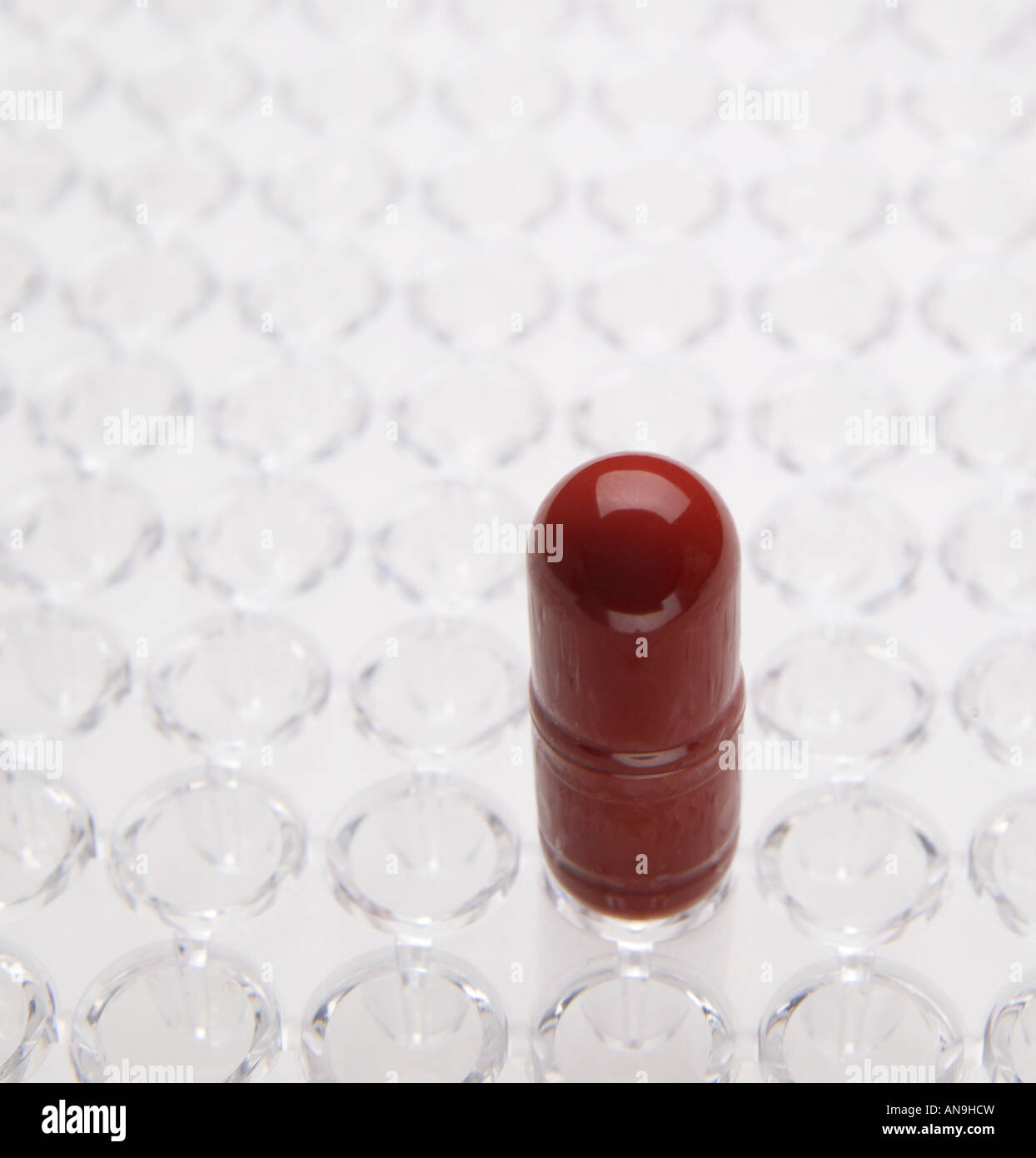Single red capsule Stock Photo - Alamy