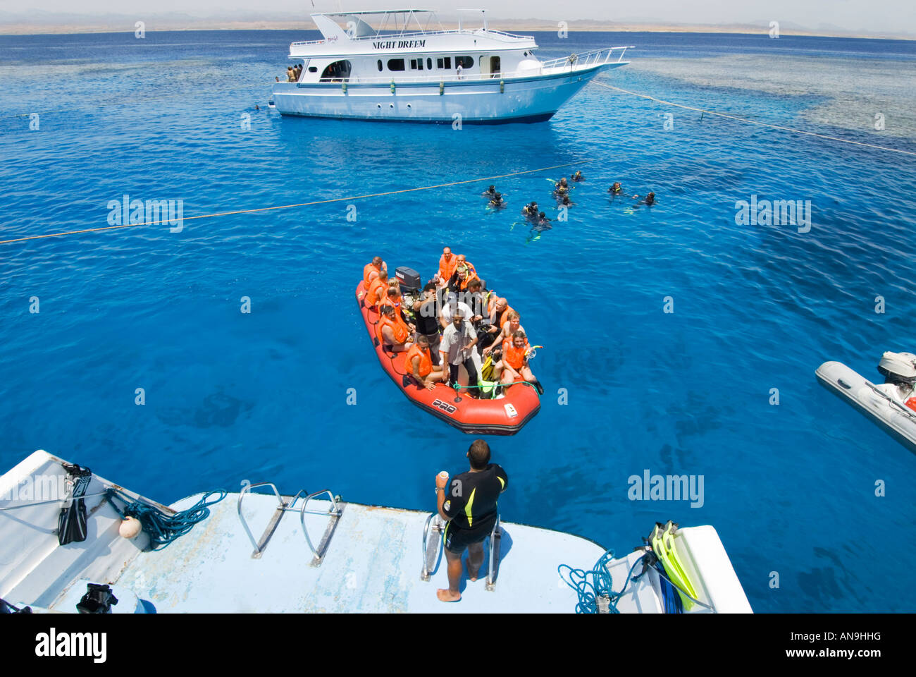 scuba divers going out by boat ship waterline surface people diving ...