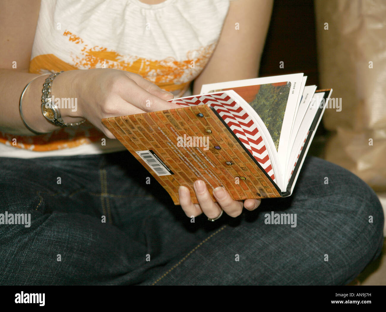 The hands of a female thumbing through the pages of a book Stock Photo ...