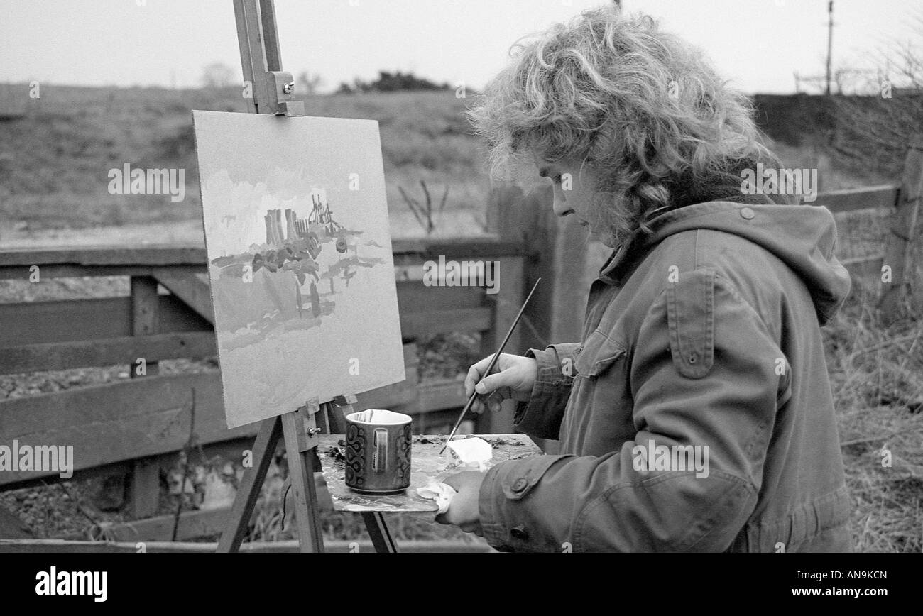 Artist working in open painting a derilict industrial scene Stock Photo ...