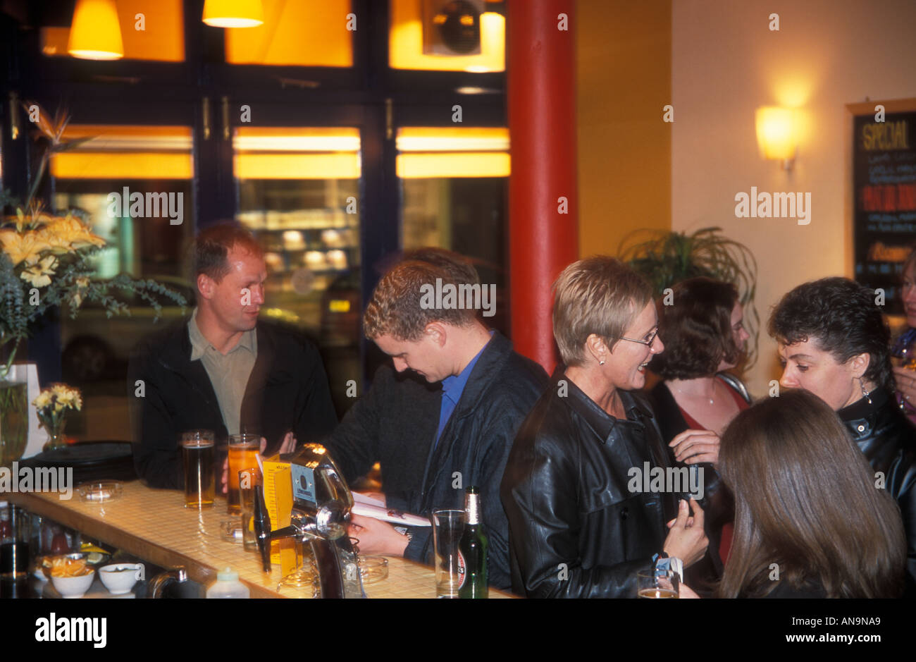 People standing at a bar Stock Photo - Alamy