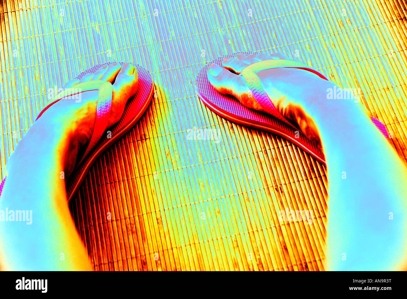 Feet in flip-flops on bamboo rug Stock Photo - Alamy