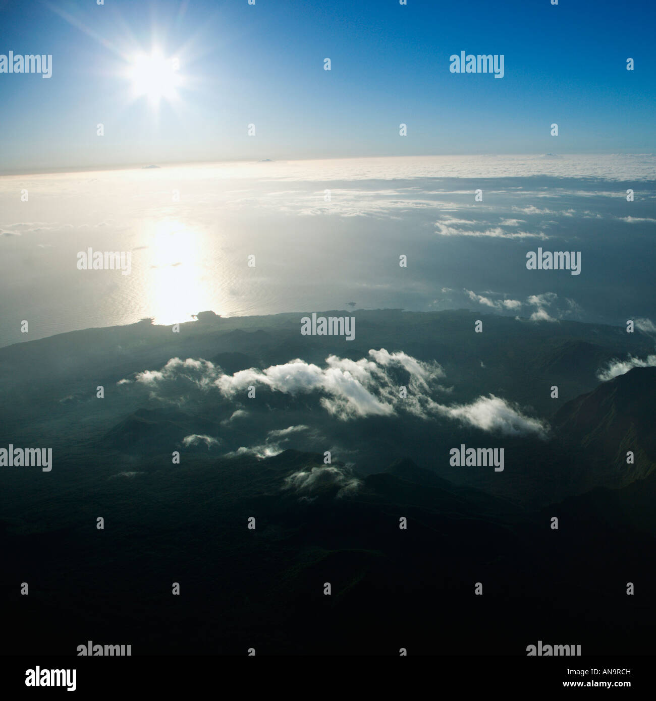 Aerial view of mountainous terrain in Maui Hawaii with sun shining off ...