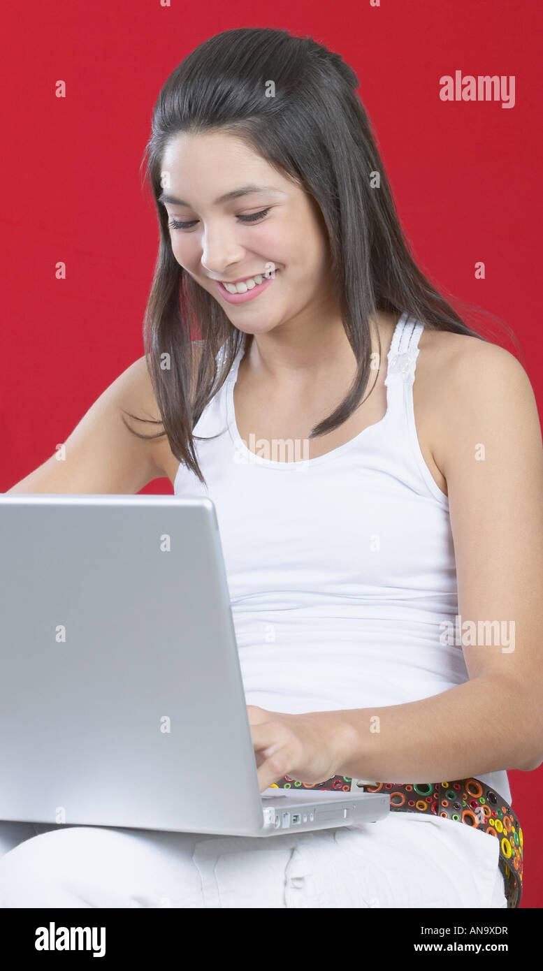Hispanic girl typing on laptop Stock Photo - Alamy