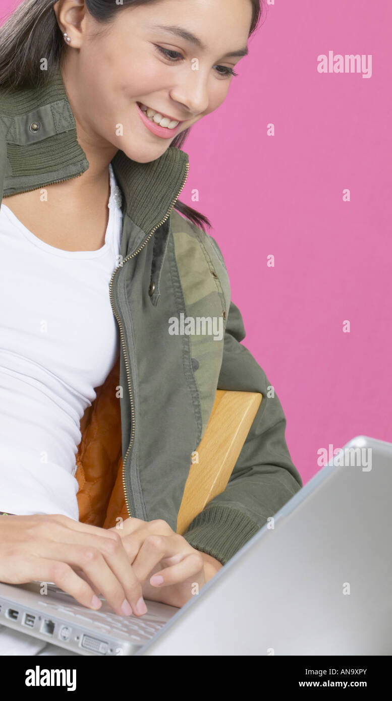 Hispanic girl typing on laptop Stock Photo - Alamy