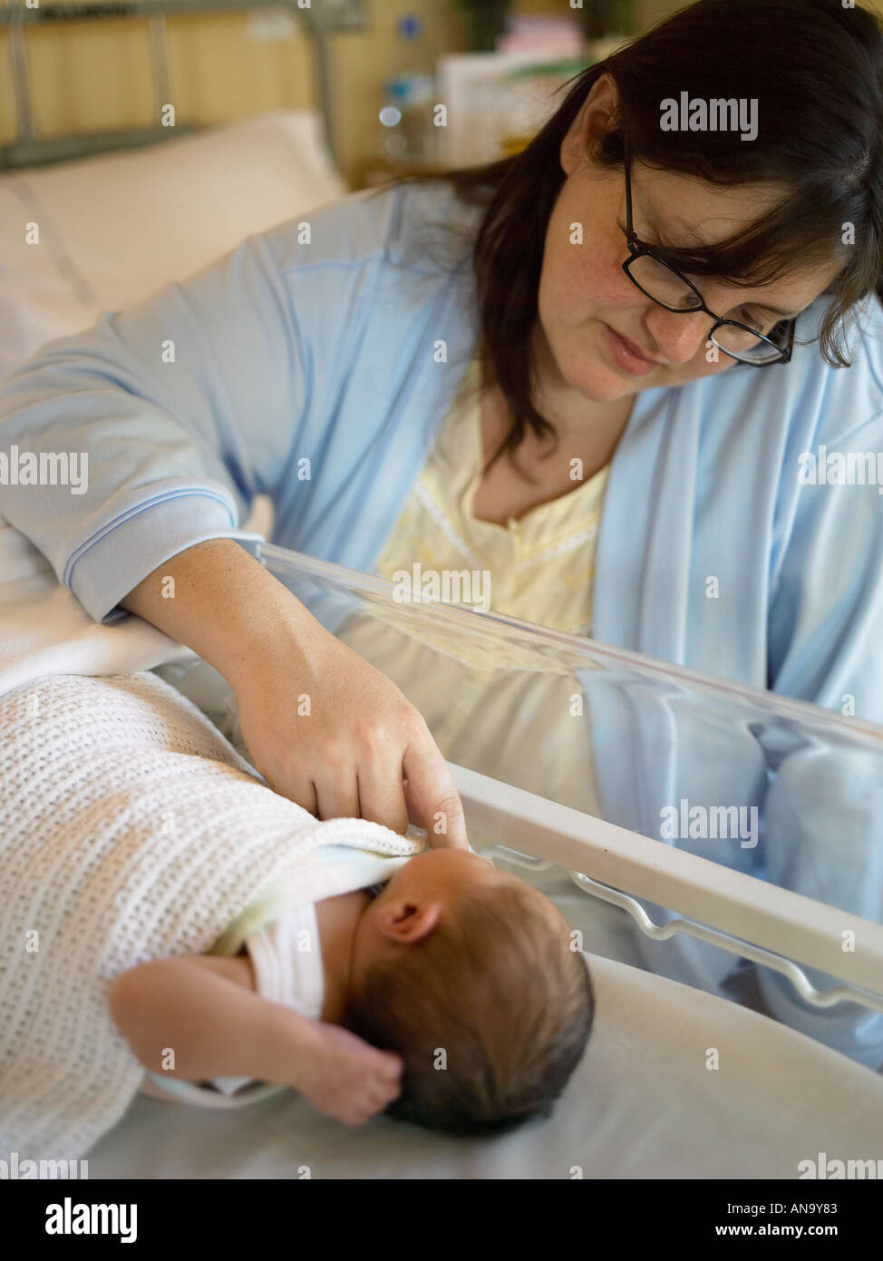 young mother touching her newborn baby Stock Photo - Alamy