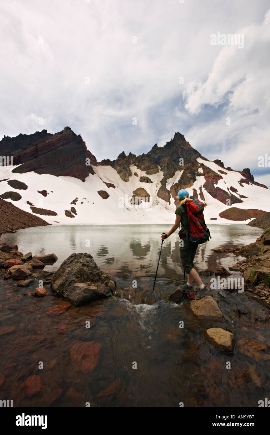 Woman backpacker below Broken Top Stock Photo - Alamy