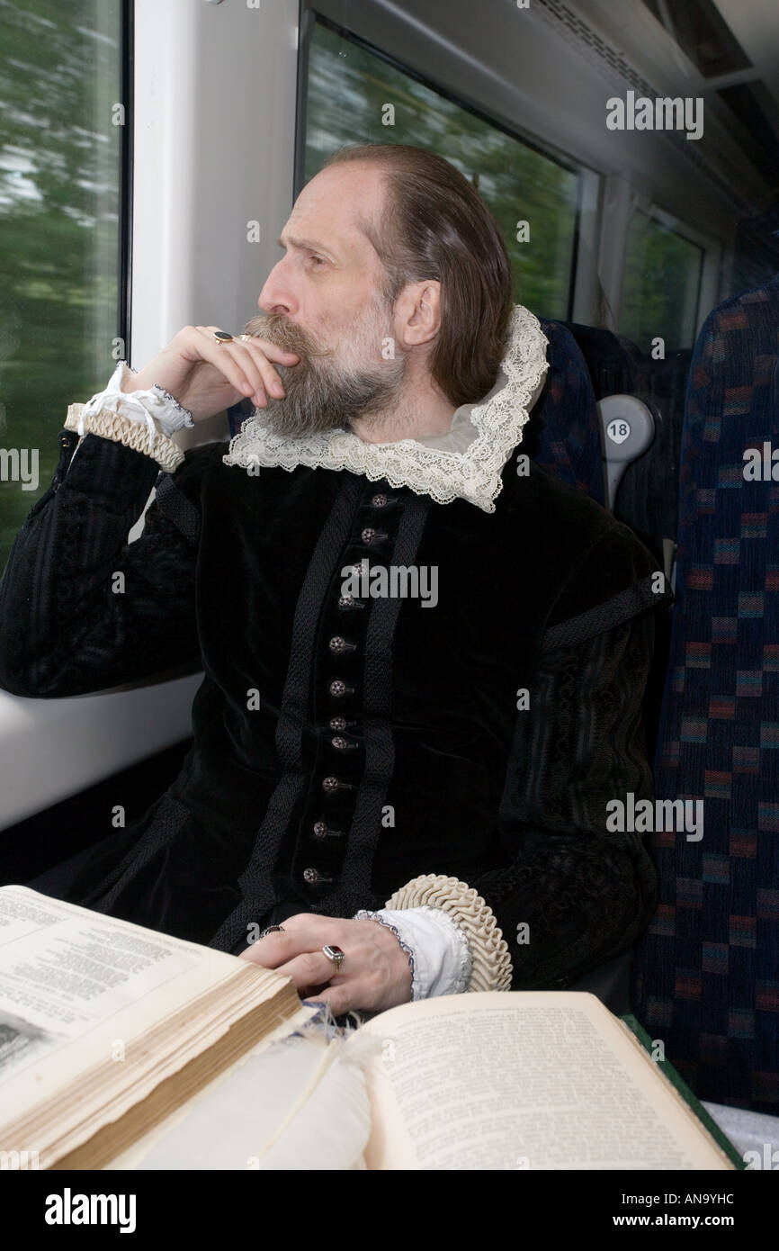 A Shakespear look a like on a train. Reading a book or looking out of ...