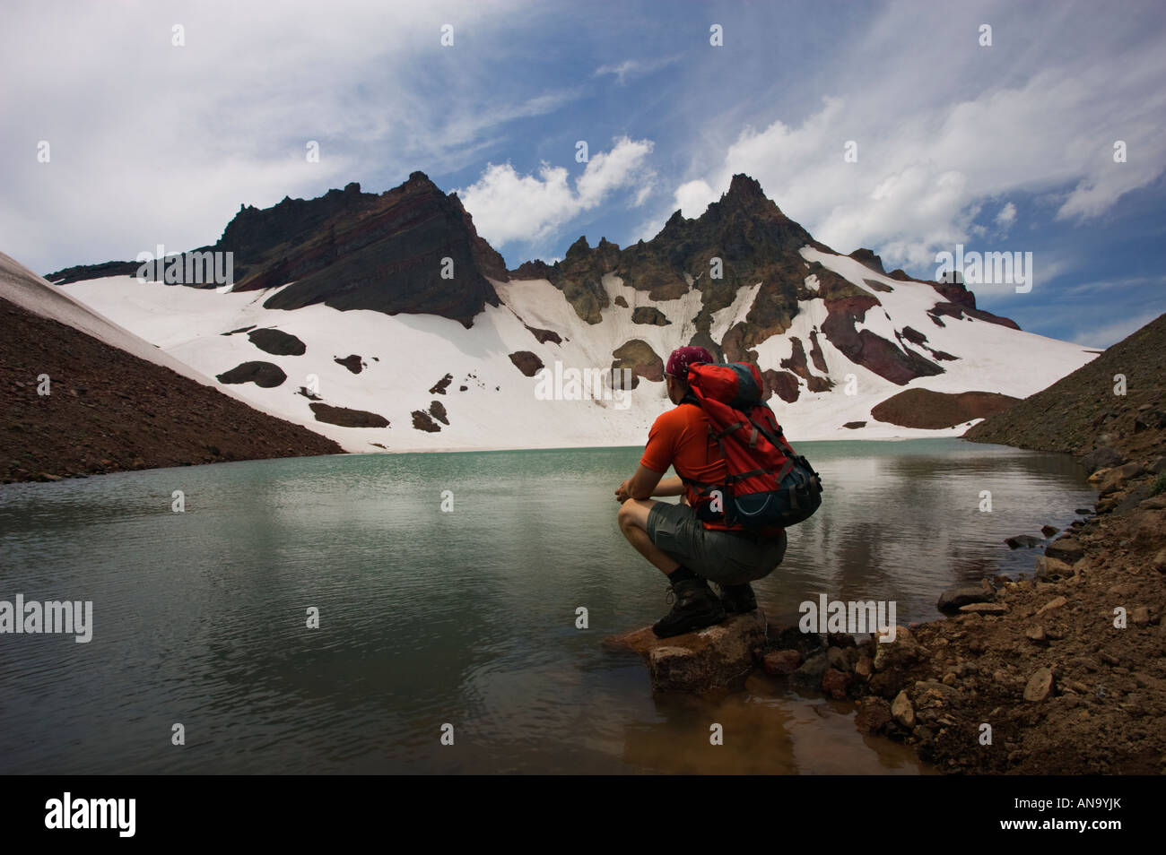 Backpacker below Broken Top Stock Photo - Alamy