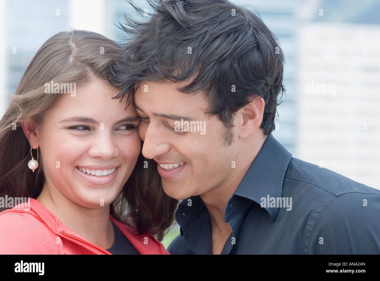 Hispanic couple hugging outdoors Stock Photo - Alamy