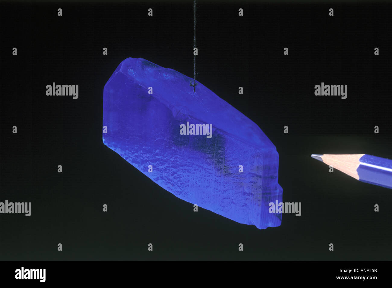 a large copper sulphate crystal with a pencil for scale Stock Photo - Alamy