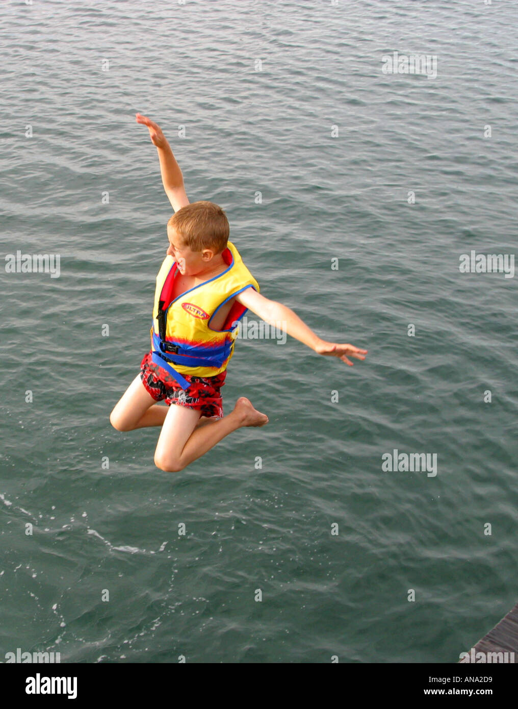 Boy jumping off pier hi-res stock photography and images - Alamy