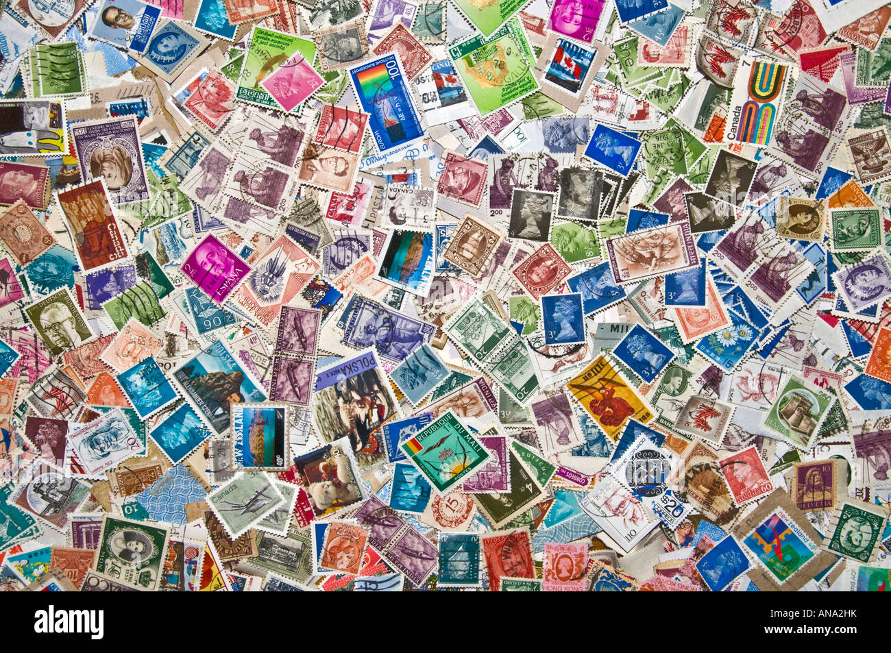 Large assortment of colorful overlapping stamps from many countries ...
