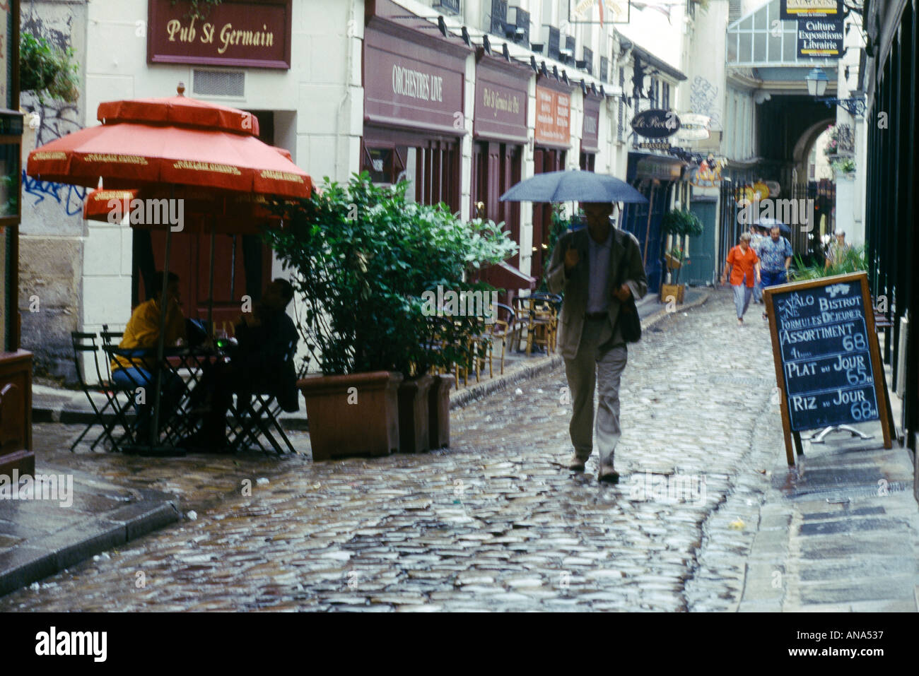 Paris France Boulevard St Germain Man Walking in Rain Stock Photo - Alamy