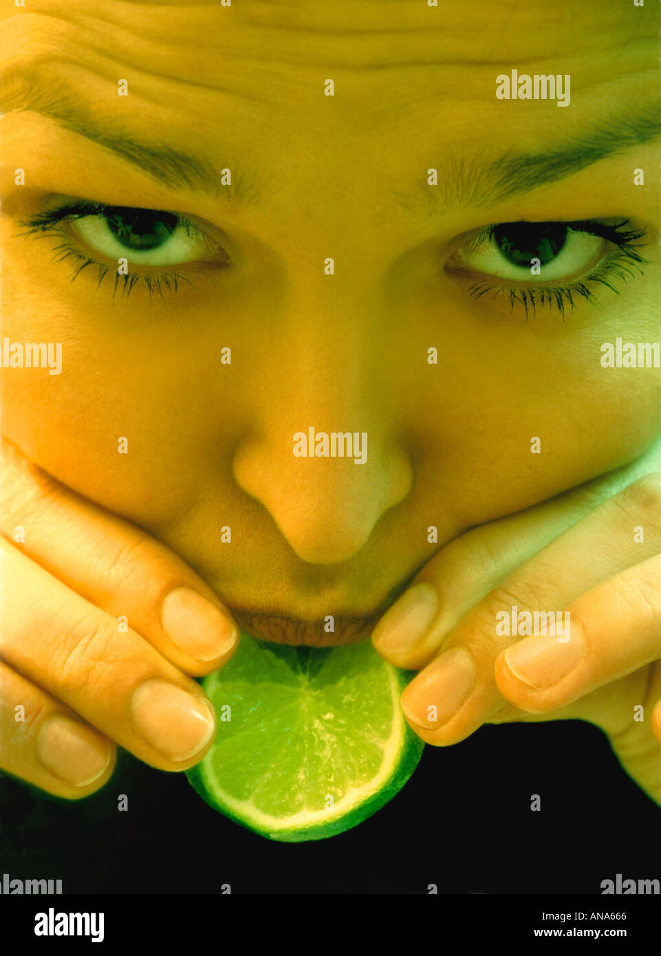 Woman eating lime green Stock Photo - Alamy