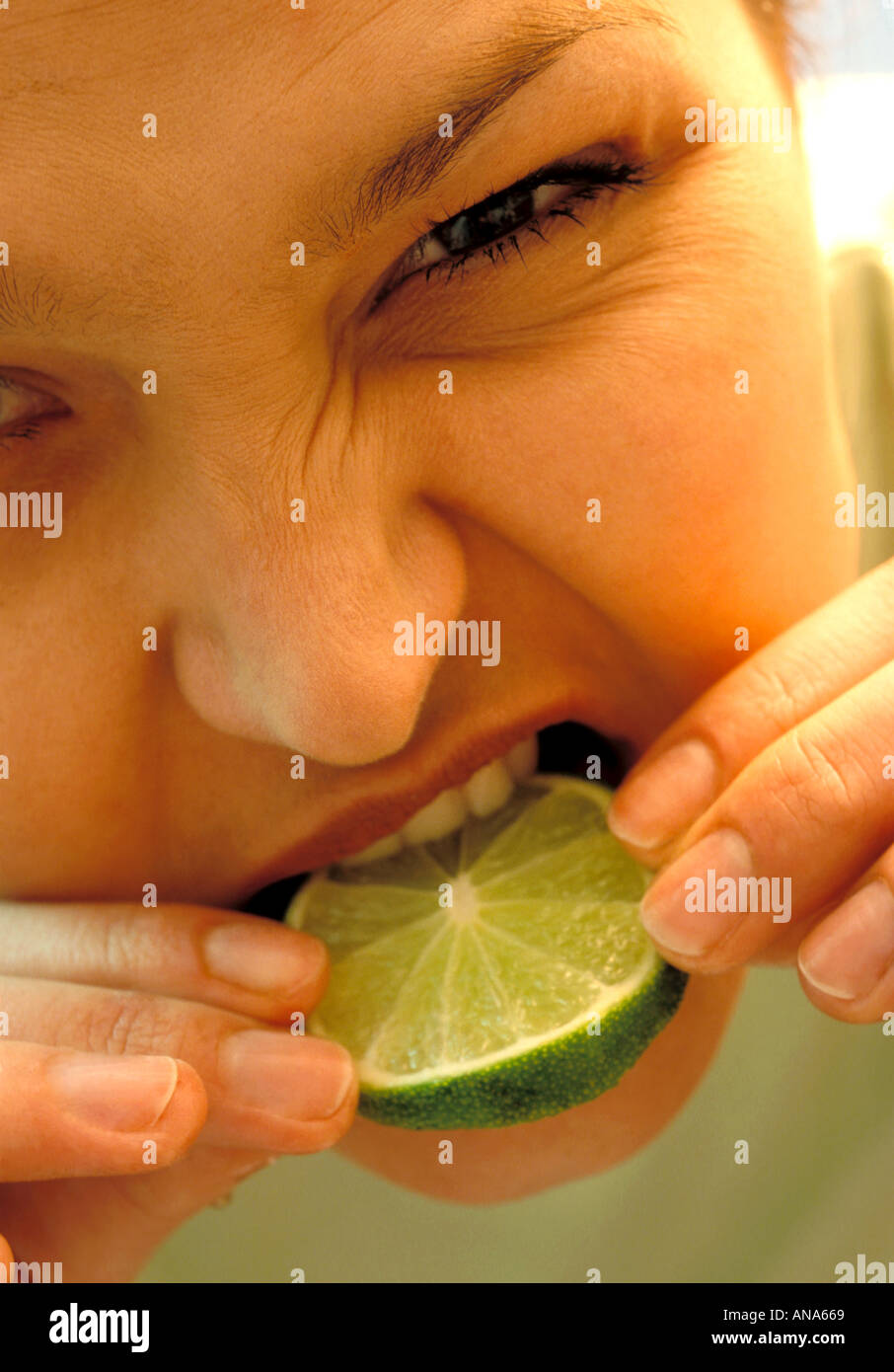 Woman eating lime Stock Photo - Alamy
