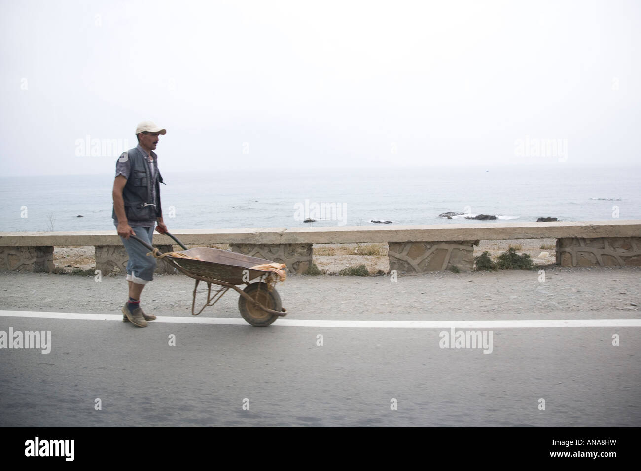 Construction worker with a wheelbarrow, Morocco Stock Photo - Alamy