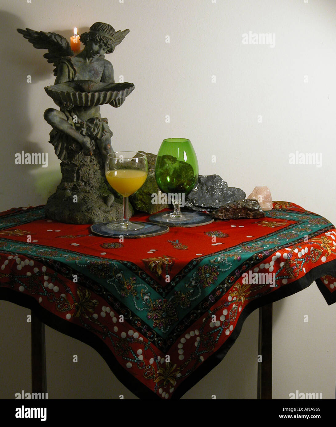 statue of angel on table with glasses Stock Photo - Alamy