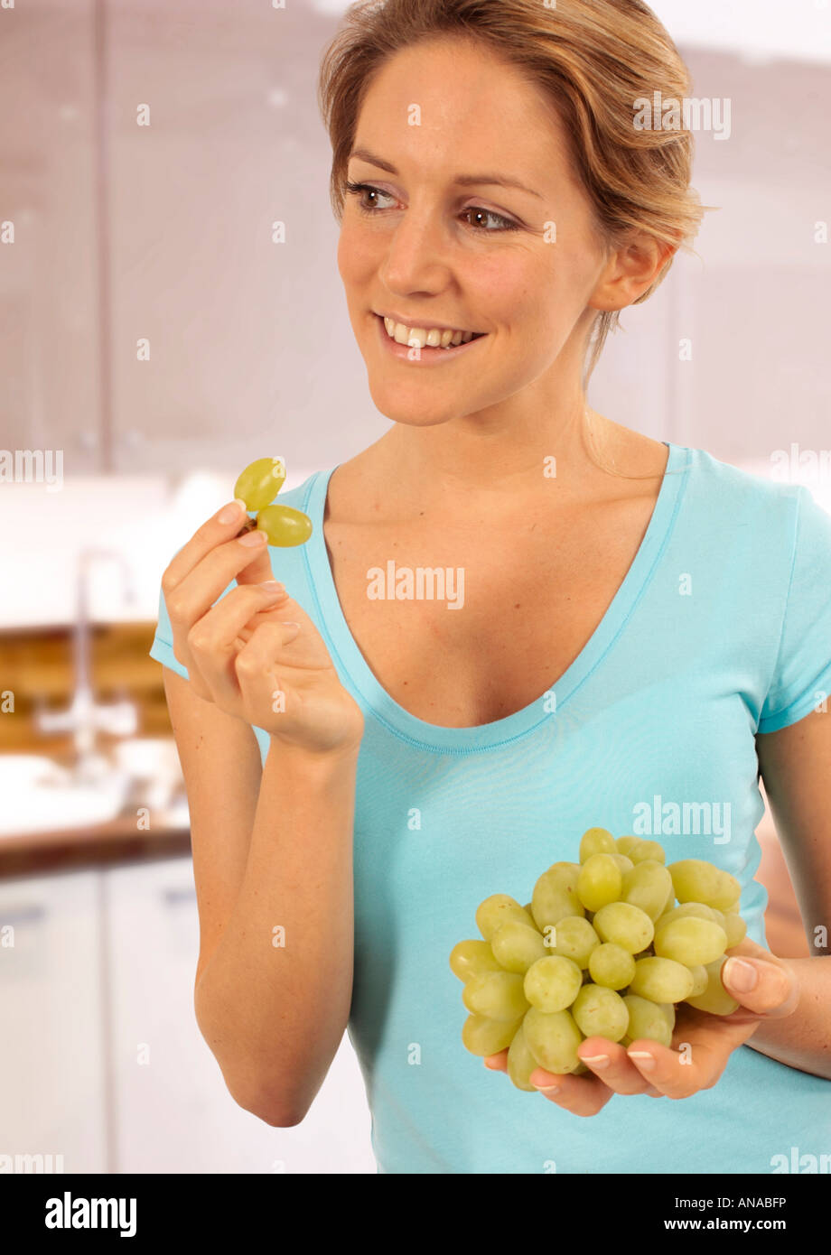 GIRL EATING GRAPES Stock Photo - Alamy