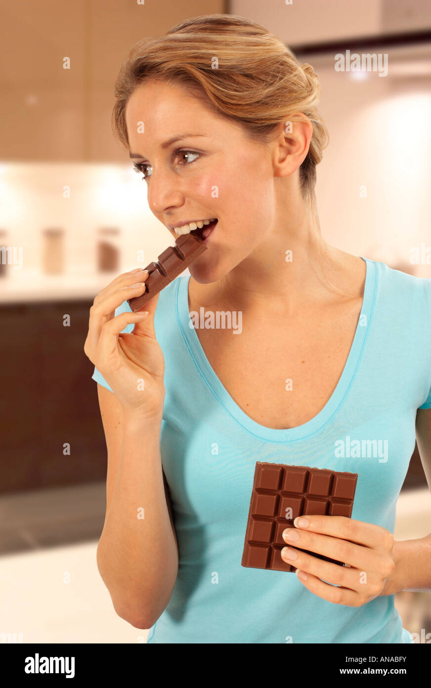 GIRL EATING BAR OF CHOCOLATE Stock Photo - Alamy