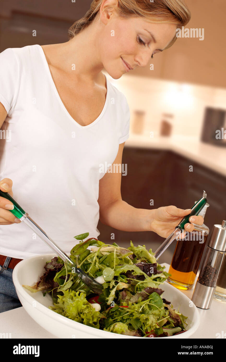 WOMAN IN KITCHEN MAKING SALAD Stock Photo - Alamy