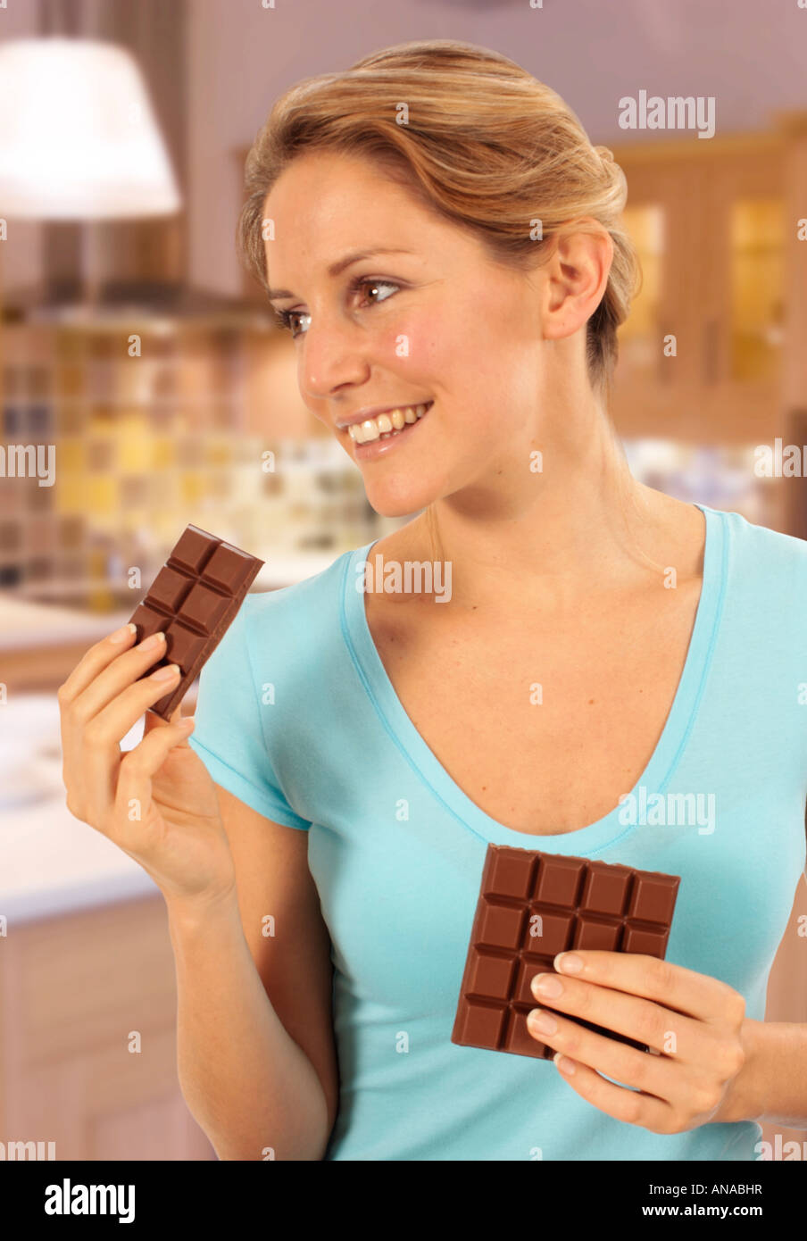 GIRL EATING BAR OF CHOCOLATE Stock Photo - Alamy
