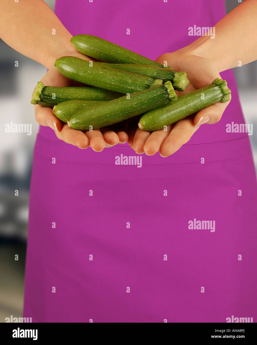 WOMAN HOLDING BABY COURGETTES / ZUCCHINI Stock Photo - Alamy
