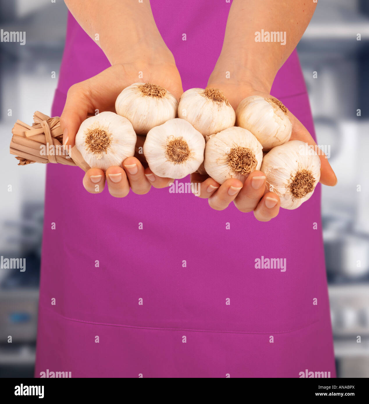 WOMAN HOLDING STRING OF GARLIC Stock Photo - Alamy